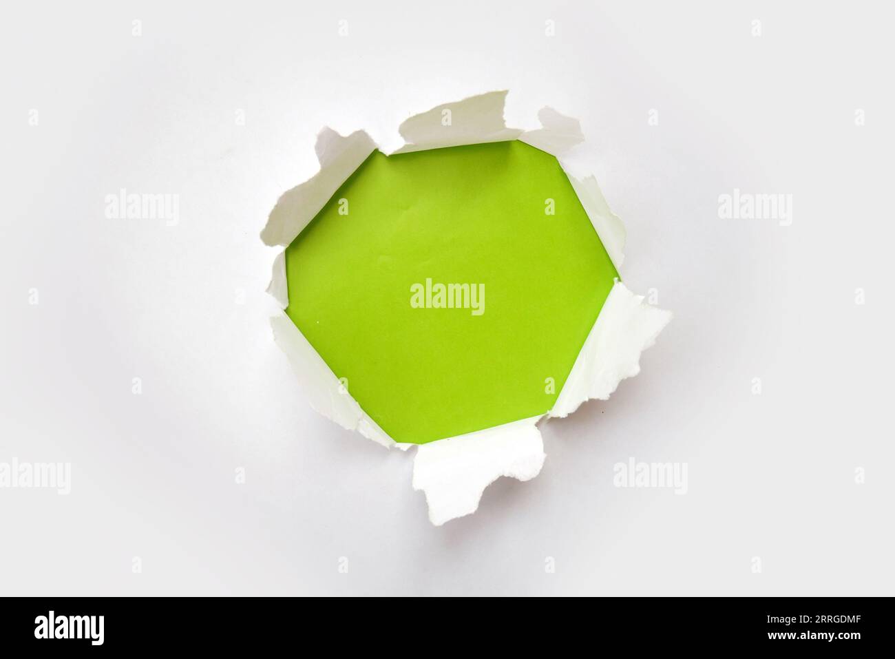 Big paper hole in the middle of pink background. Blank space to insert ...