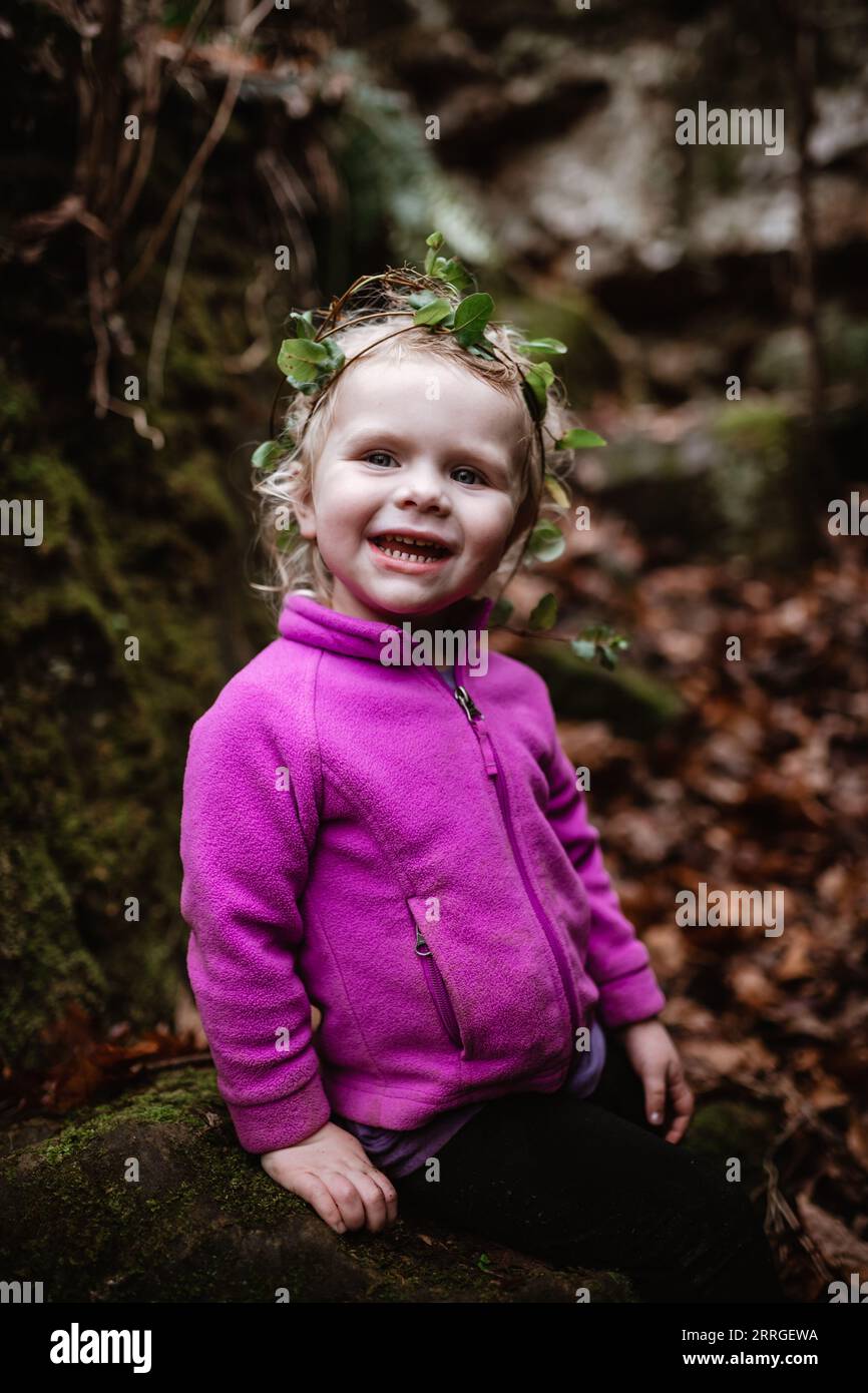 Child posing outdoors wearing a natural ivy crown Stock Photo - Alamy