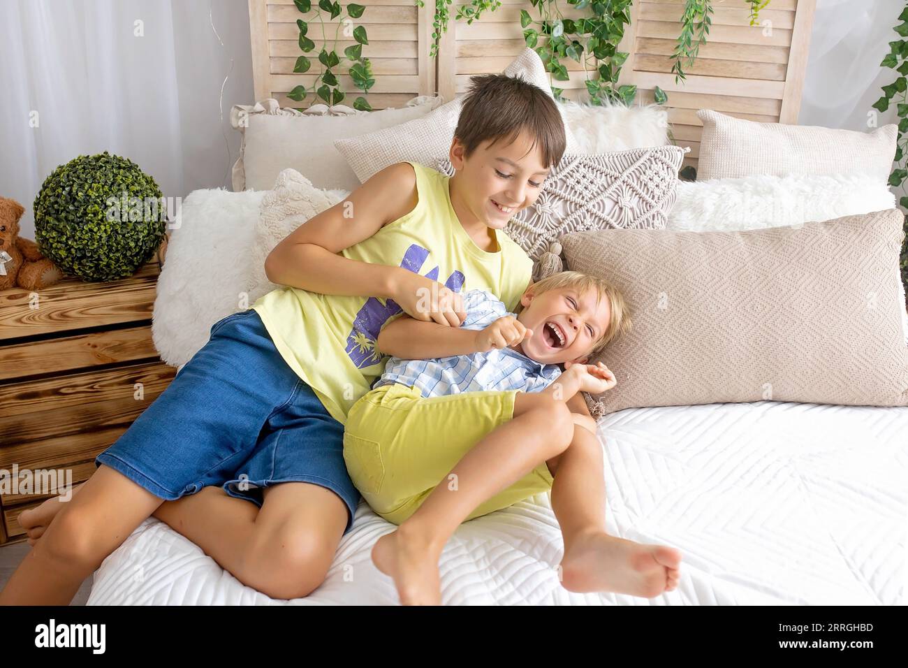 Happy positive children, tickling on the feet, having fun together, boy ...