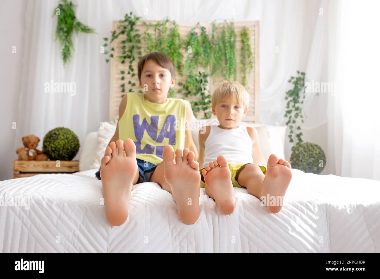 Happy positive children, tickling on the feet, having fun together, boy ...