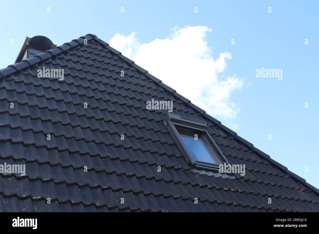 Roof Window In Velux Style With Black Roof Tiles Stock Photo - Alamy