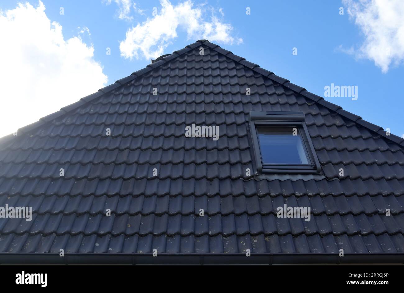 Roof Window In Velux Style With Black Roof Tiles Stock Photo - Alamy