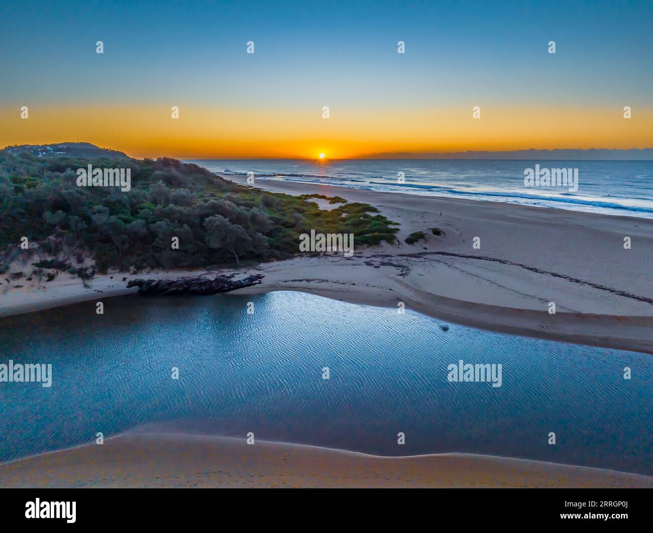 Aerial sunrise with the lagoon open to the sea at Wamberal Beach on the ...