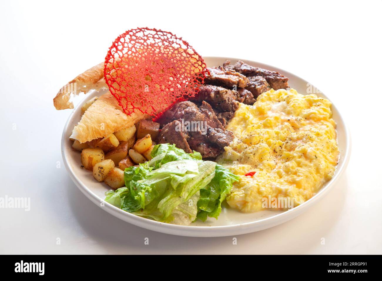 Scrambled eggs with tenderloin beef steak and sautéed vegetables Stock ...