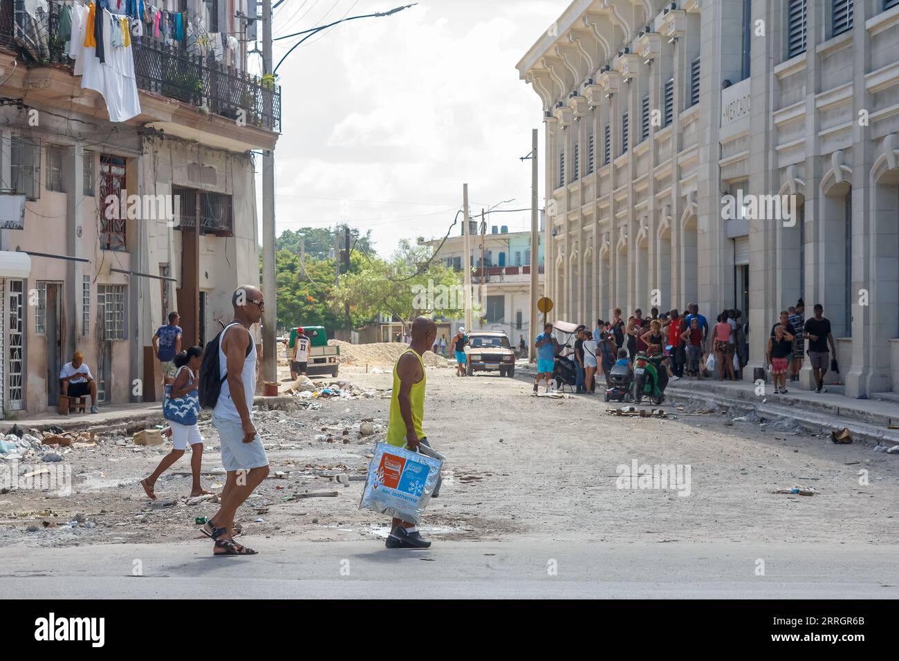 Havana, Cuba - September 3, 2023: Cuban people walking on a broken and ...