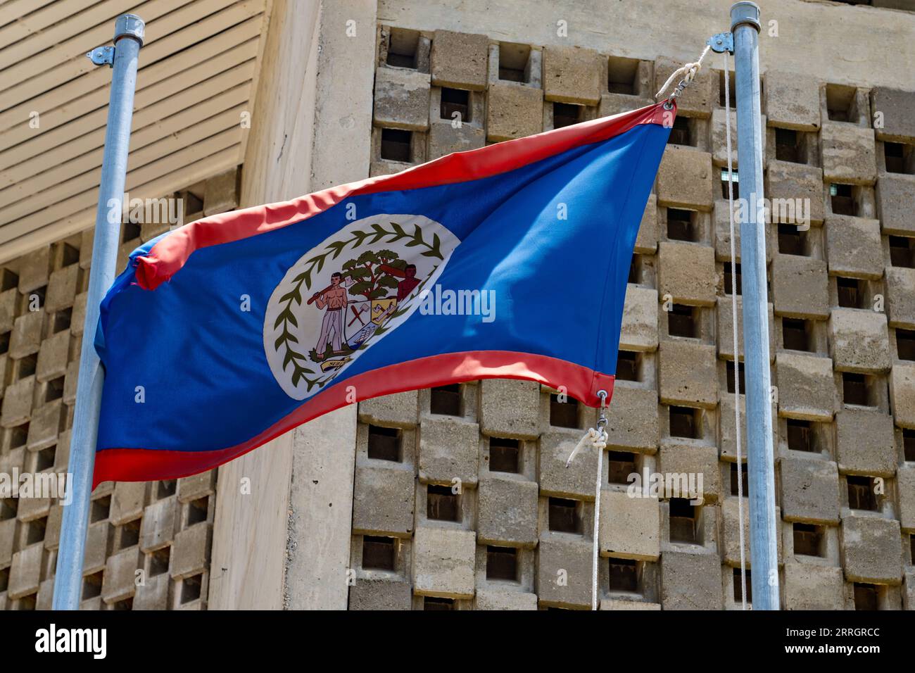 The national flag of Belize, flying beside the National Assembly ...