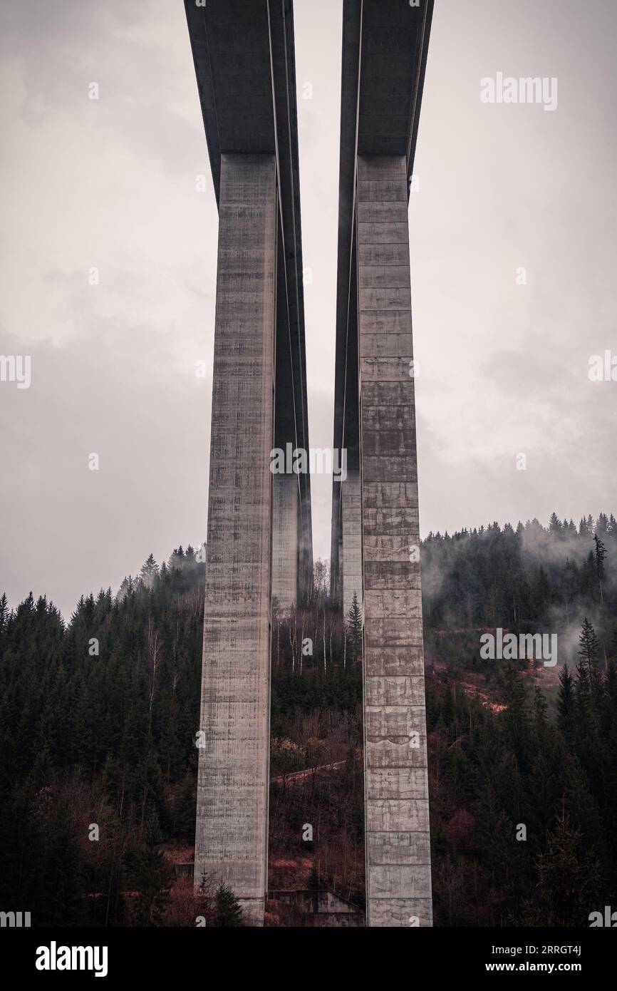 A stark architectural scene of a large bridge with several tall ...