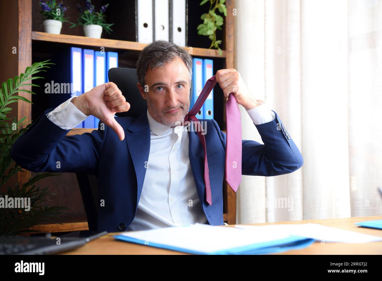 Thumbs down businessman sitting in hi-res stock photography and images ...