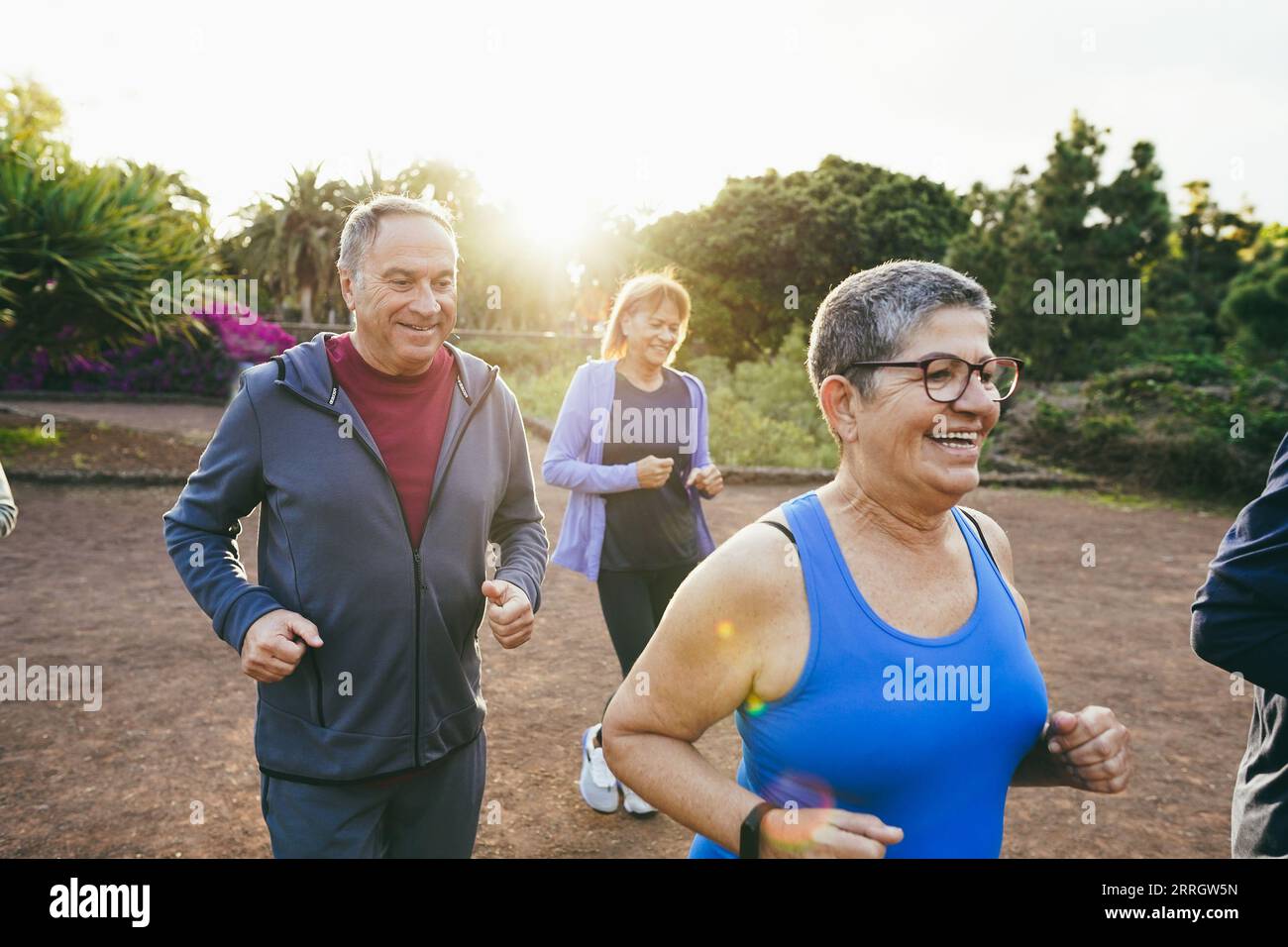 Fit senior people running at city park - Group of elderly friends doing ...