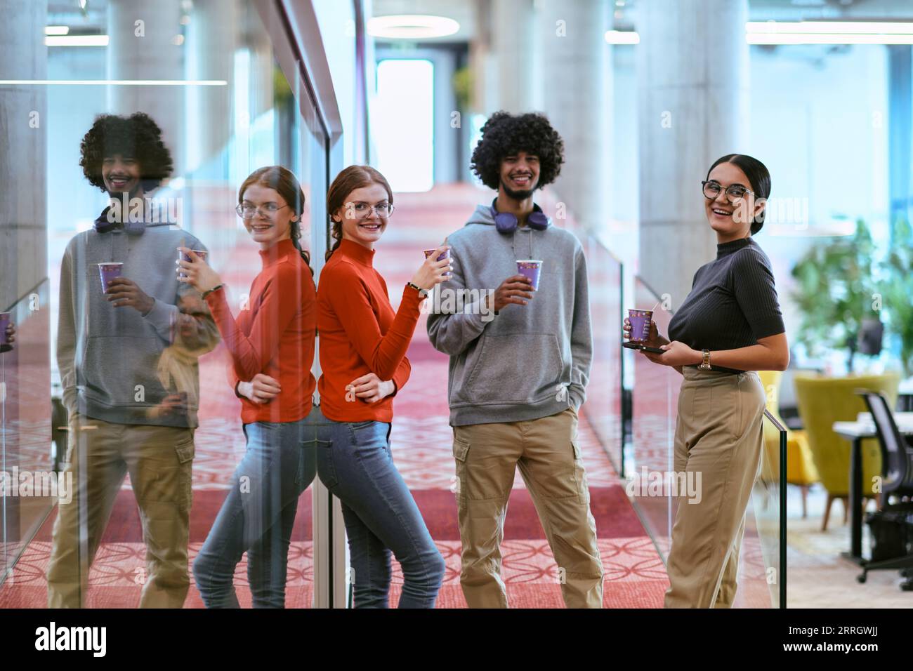 Amidst the modern glass walls of a startup office, a diverse group of ...