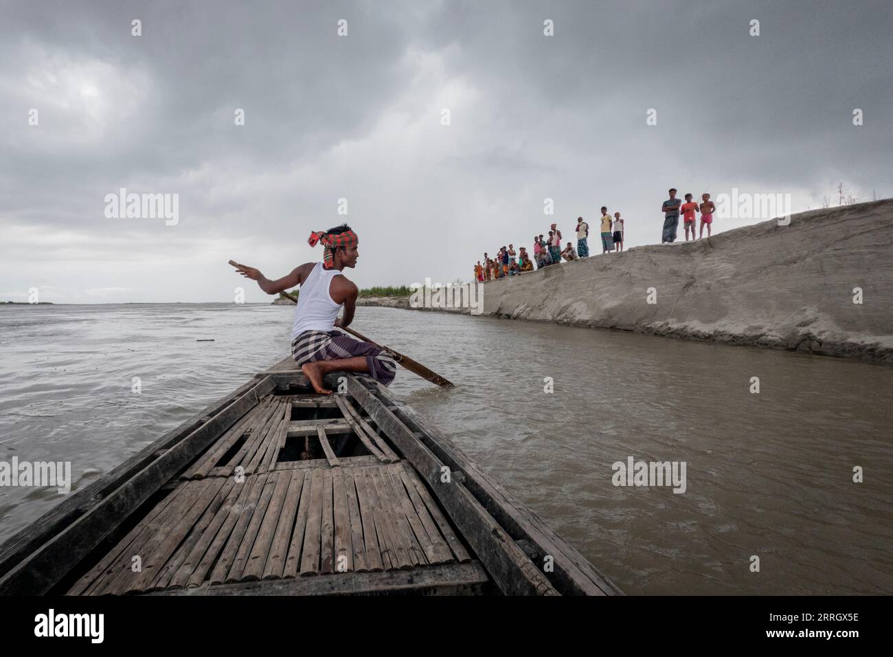 Rashed paddles his country boat alongside the villagers on the Kheyar ...