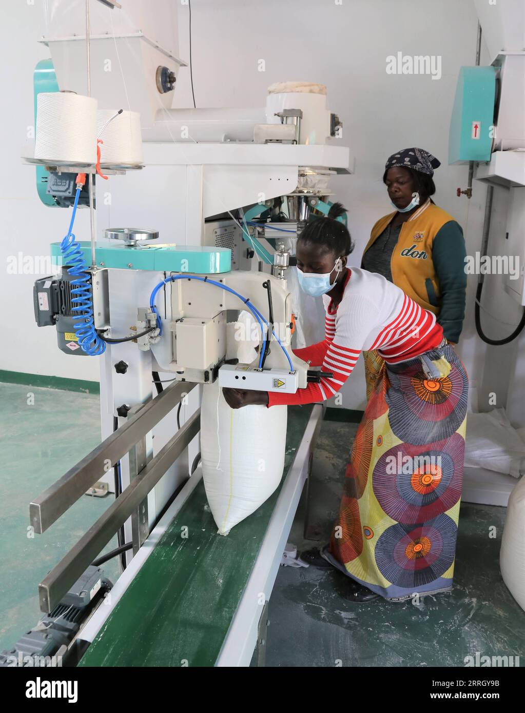220603 -- LUSAKA, June 3, 2022 -- Workers pack the mealie meal in the ...