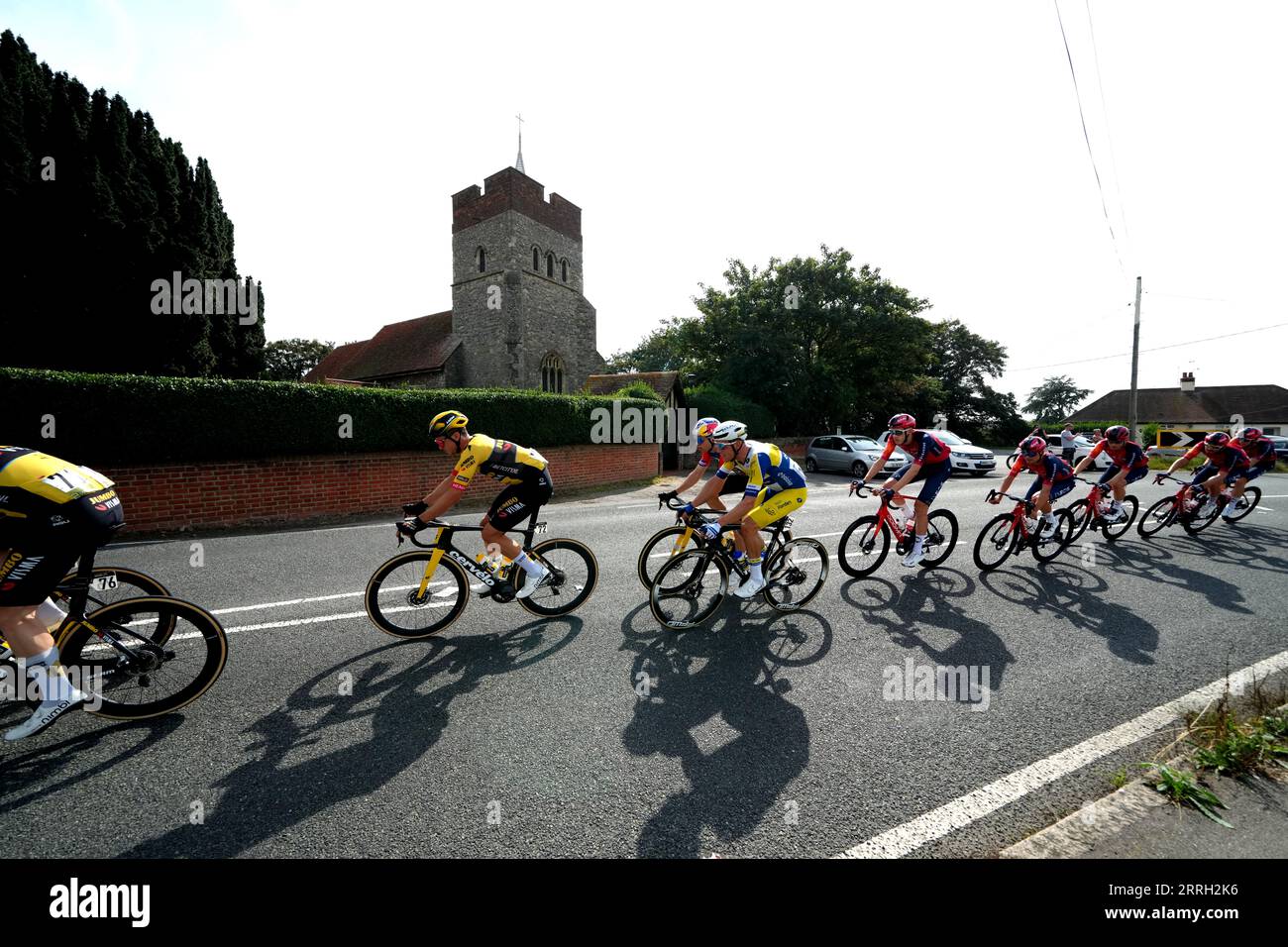 The peloton pass the St Mary & All Saints church in Stambridge during ...