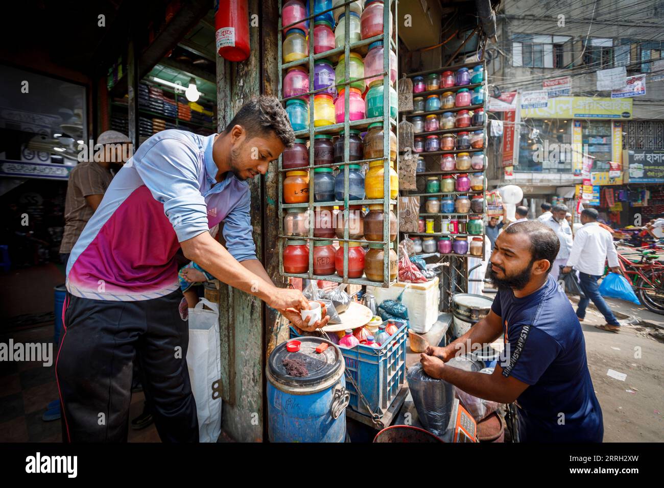A vendor sells color pigment for garment coloring to a customer in ...
