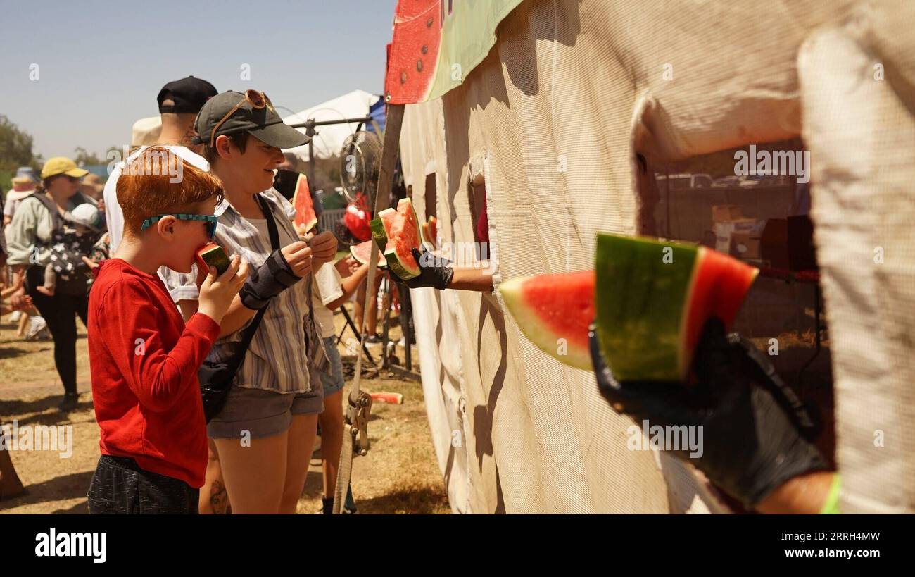 220613 -- LOS ANGELES, June 13, 2022 -- People get free watermelon ...