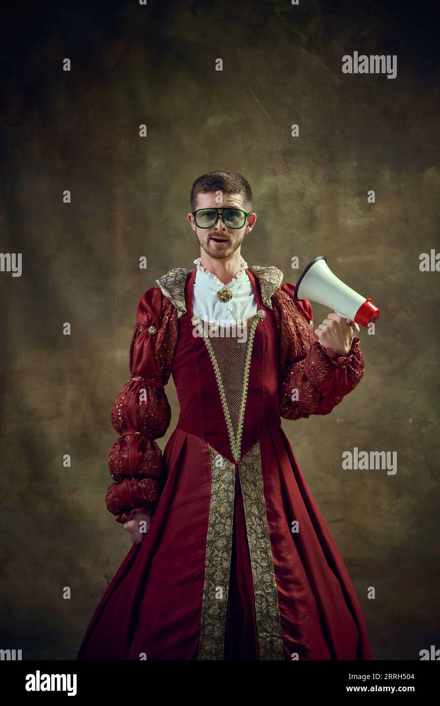 Young guy in image of medieval royal person wearing female dress and ...