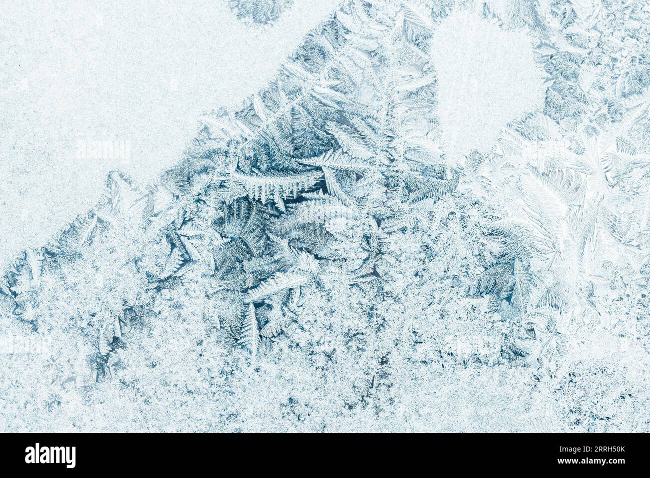 Frost pattern over a window glass, macro photo, natural blue white ...
