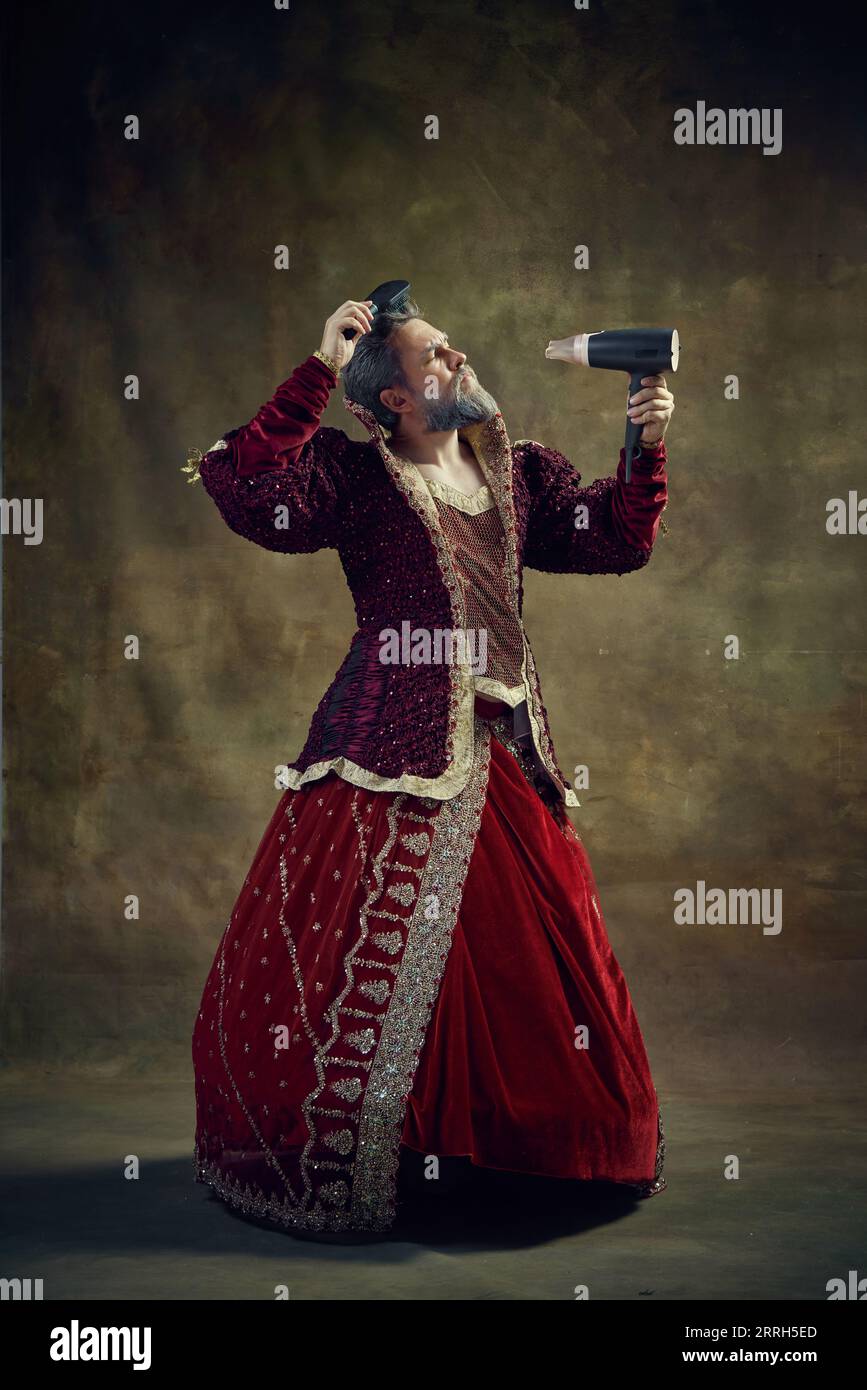 Royal person, king, monarch in female dress doing hairstyle using hair ...