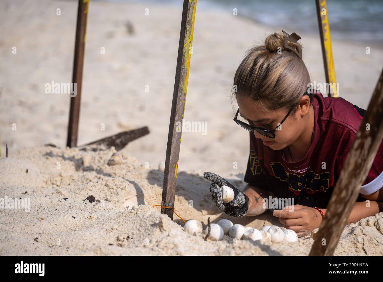 220616 -- REDANG ISLAND, June 16, 2022 -- A volunteer checks the sea ...