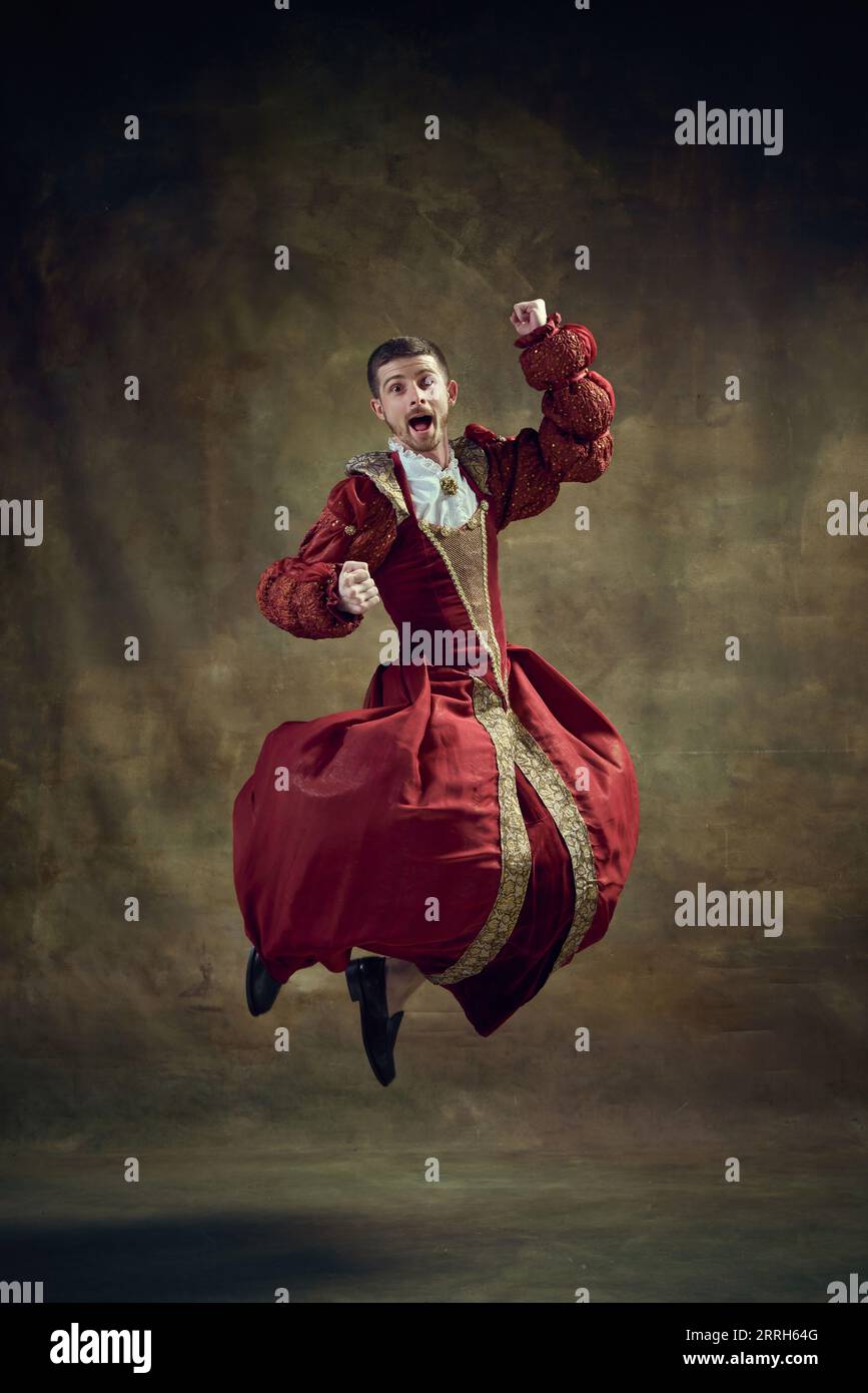 Young emotional man, medieval royal person, prince emotionally jumping ...