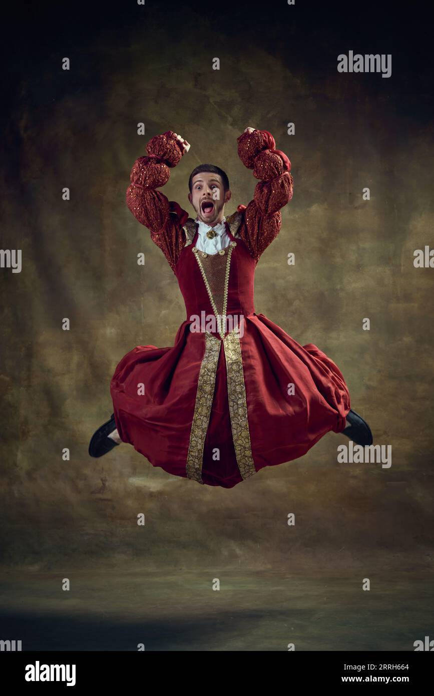 Young emotional man, medieval royal person emotionally jumping in ...