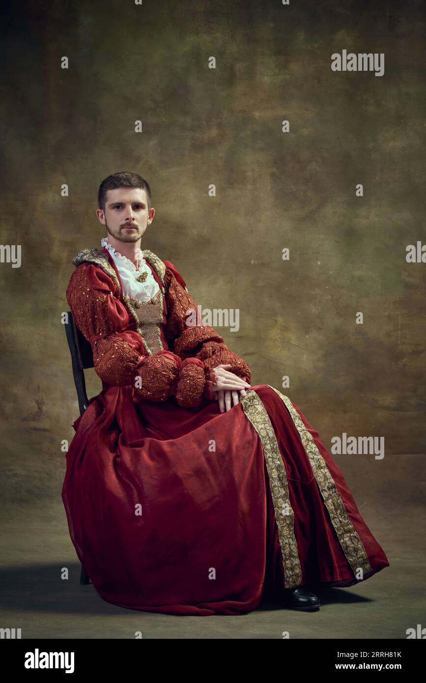 Historical portrayal. Elegant young medieval prince sitting tenderly in ...