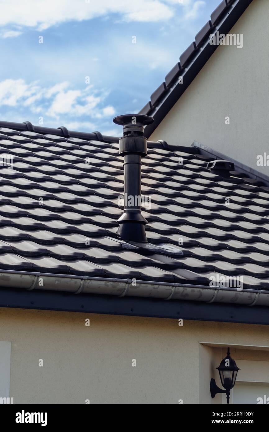 Chimney of a wood or pellet stove installed on the roof Stock Photo - Alamy