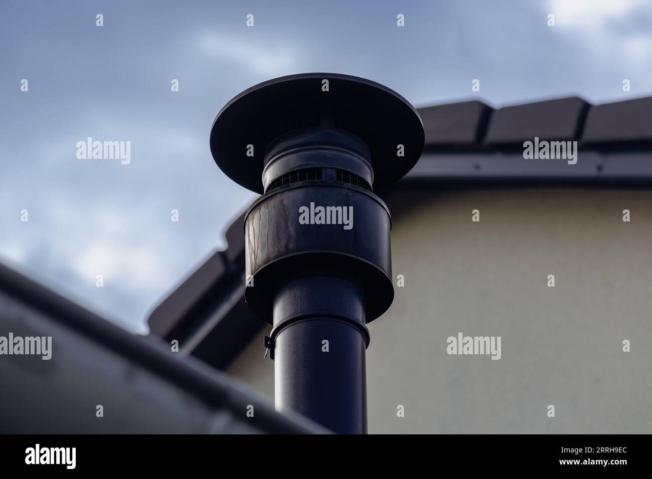Chimney of a wood or pellet stove installed on the roof Stock Photo - Alamy