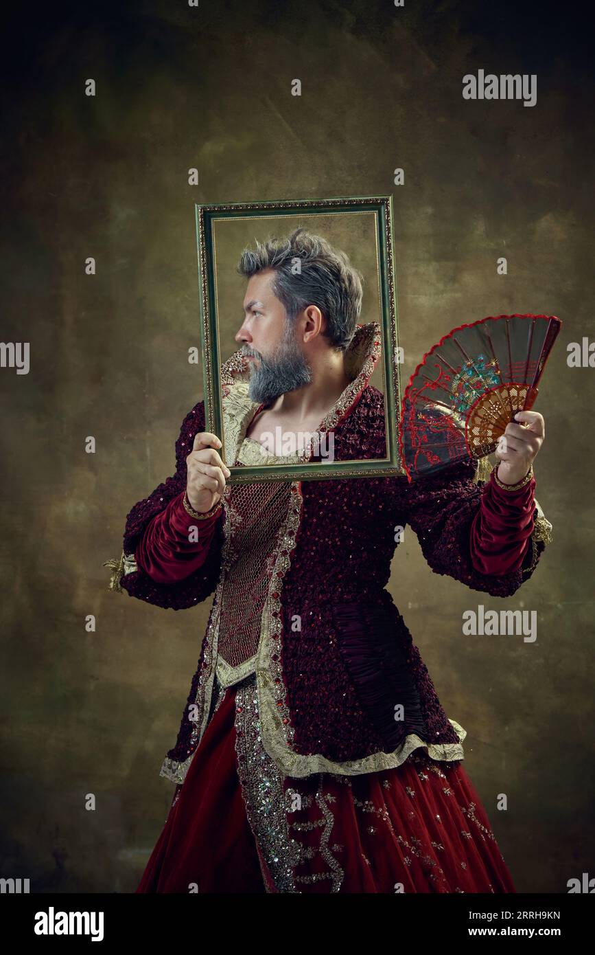 Portrait of serious nobleman, medieval king wearing female dress with ...