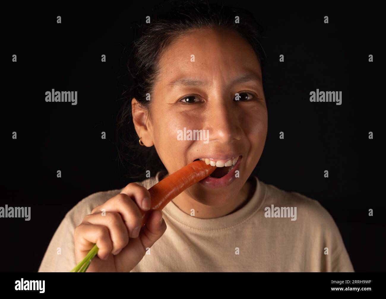 Woman biting carrot hi-res stock photography and images - Alamy