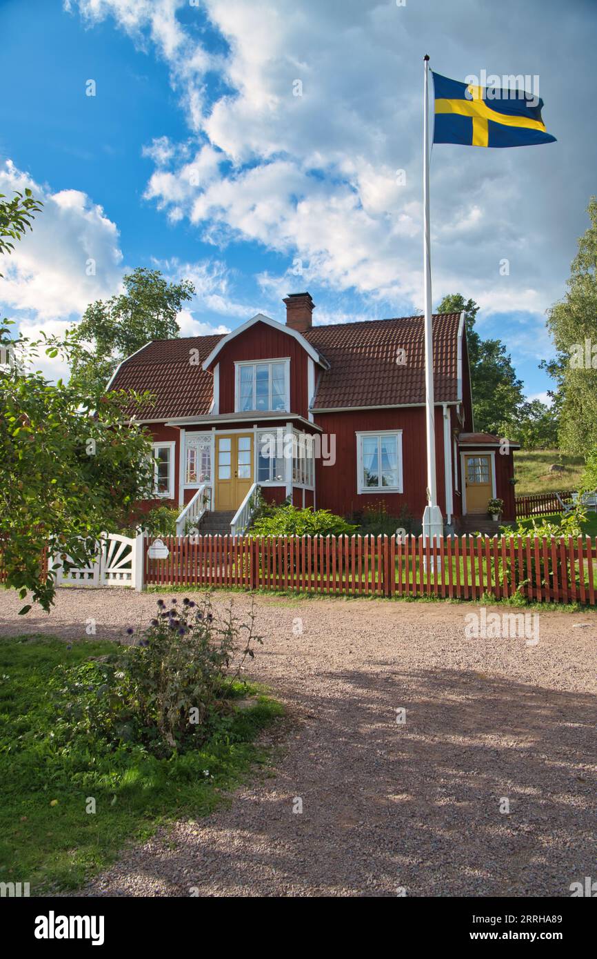 a typical red and white swedish house in smalland. White garden gate ...