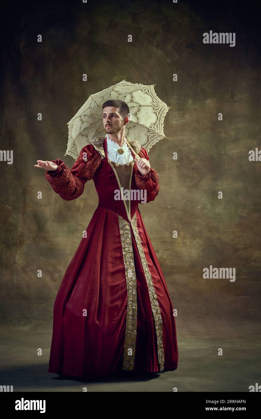 Historical royalplay. Medieval prince, nobleman in female dress ...