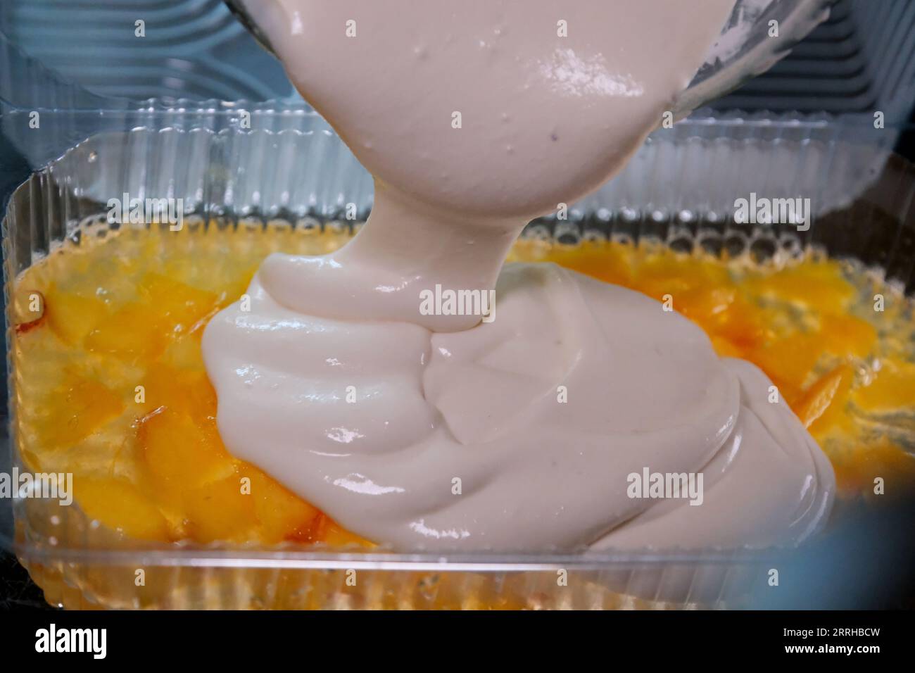 peach jelly with yogurt pour into plastic glass delicious healthy ...