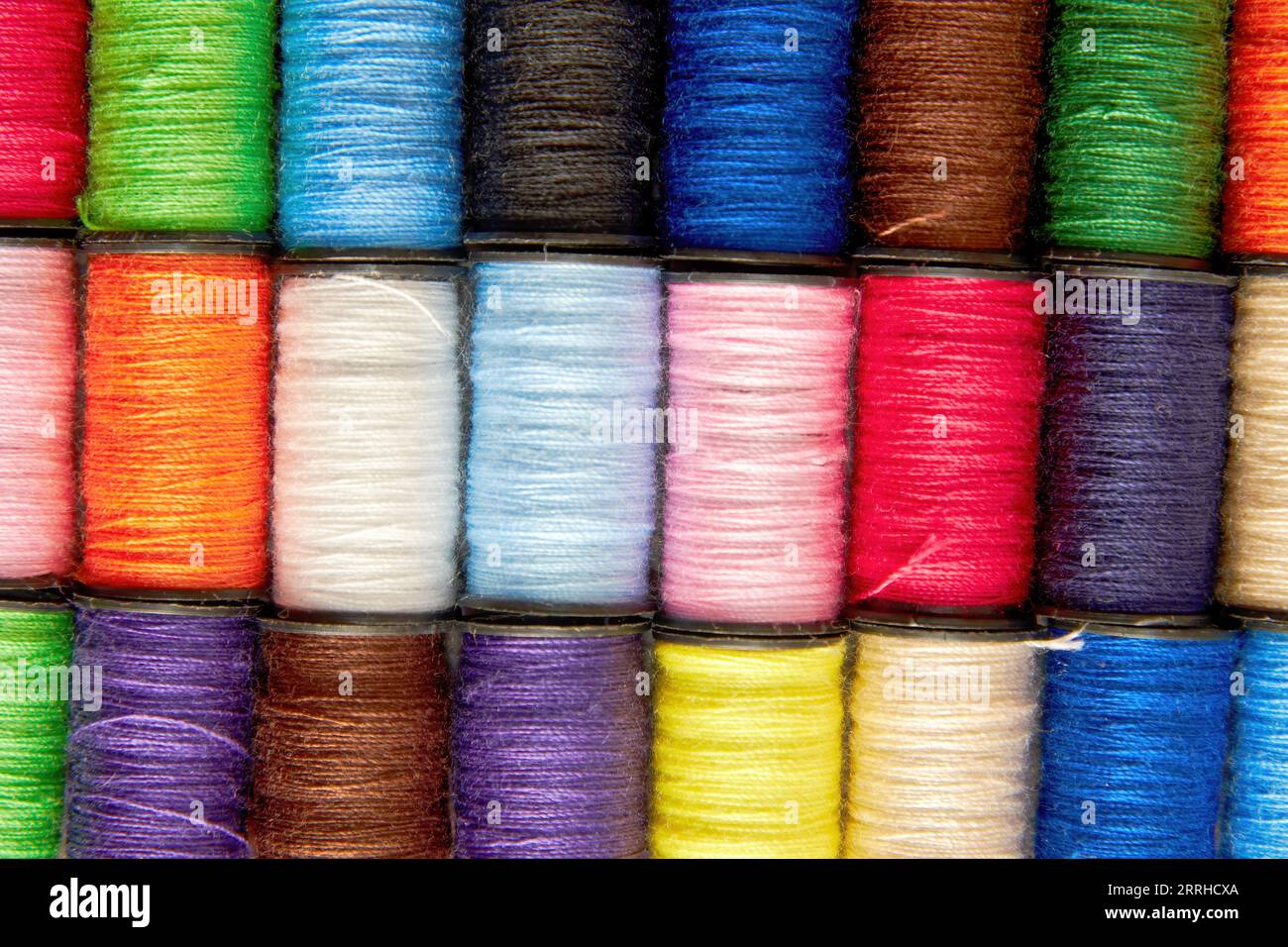 Texture pattern of the colorful thread spools. Embroidery and sewing ...
