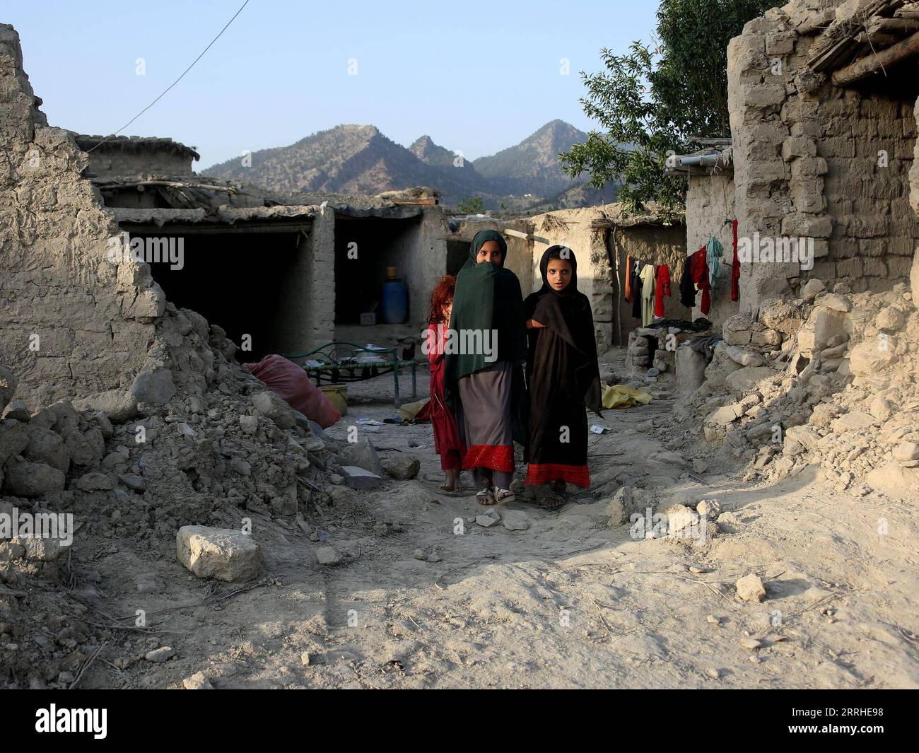 220626 -- KHOST AFGHANISTAN, June 26, 2022 -- People stand beside ...