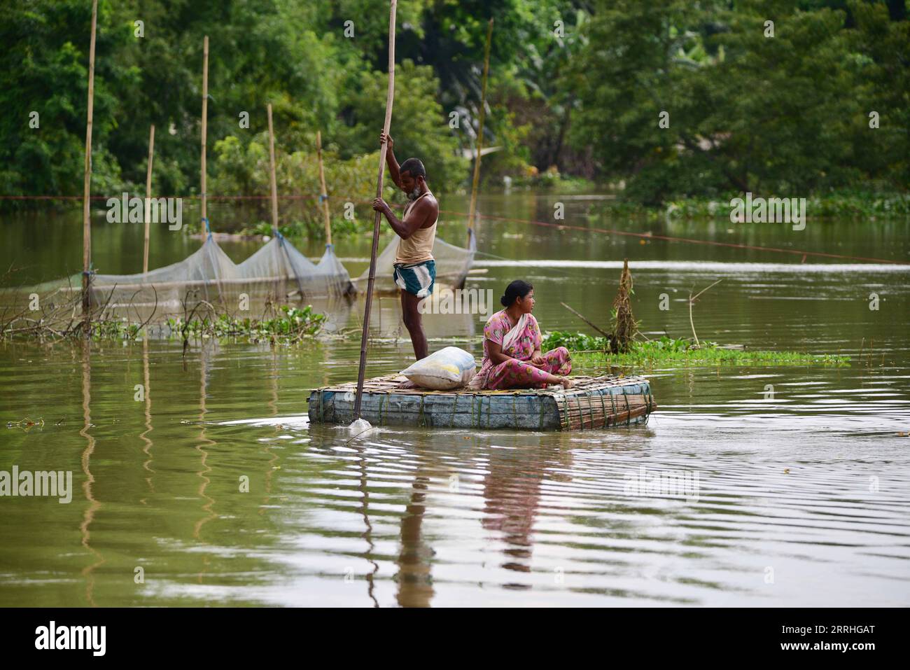 220630 -- NAGAON, June 30, 2022 -- Villagers use a makeshift raft ...
