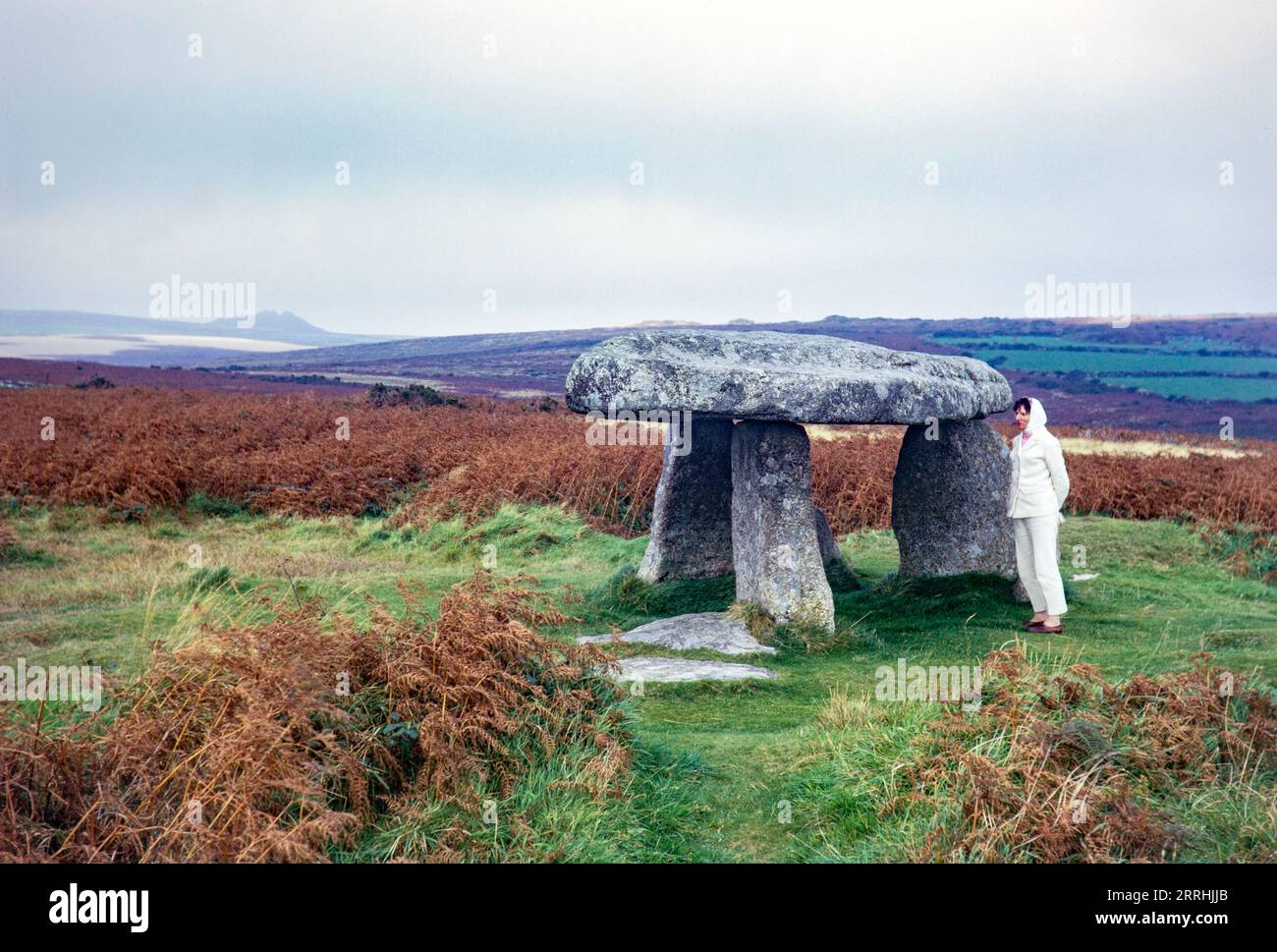 Woman standing by Lanyon Quoit prehistoric dolmen, Morvah, Cornwall ...