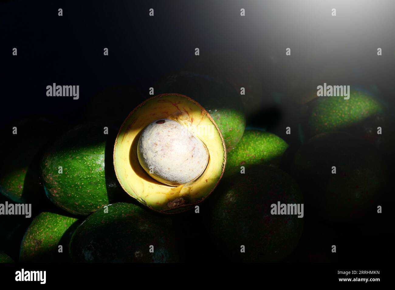 Fresh Avocados fruit on nature background Stock Photo - Alamy