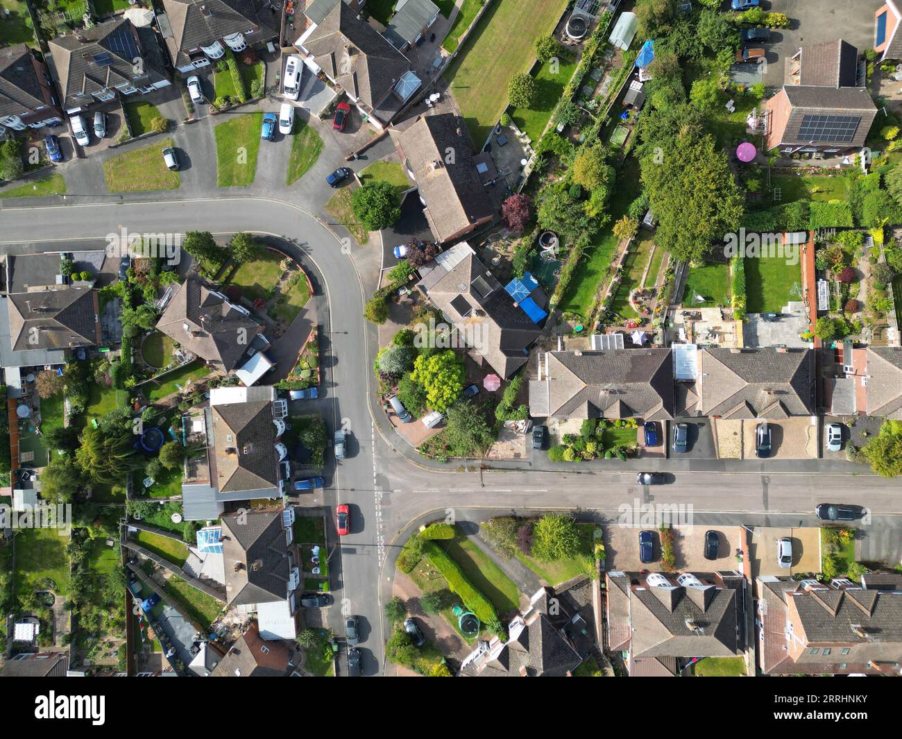 Aerial view of suburban housing with gardens and urban street layout in ...