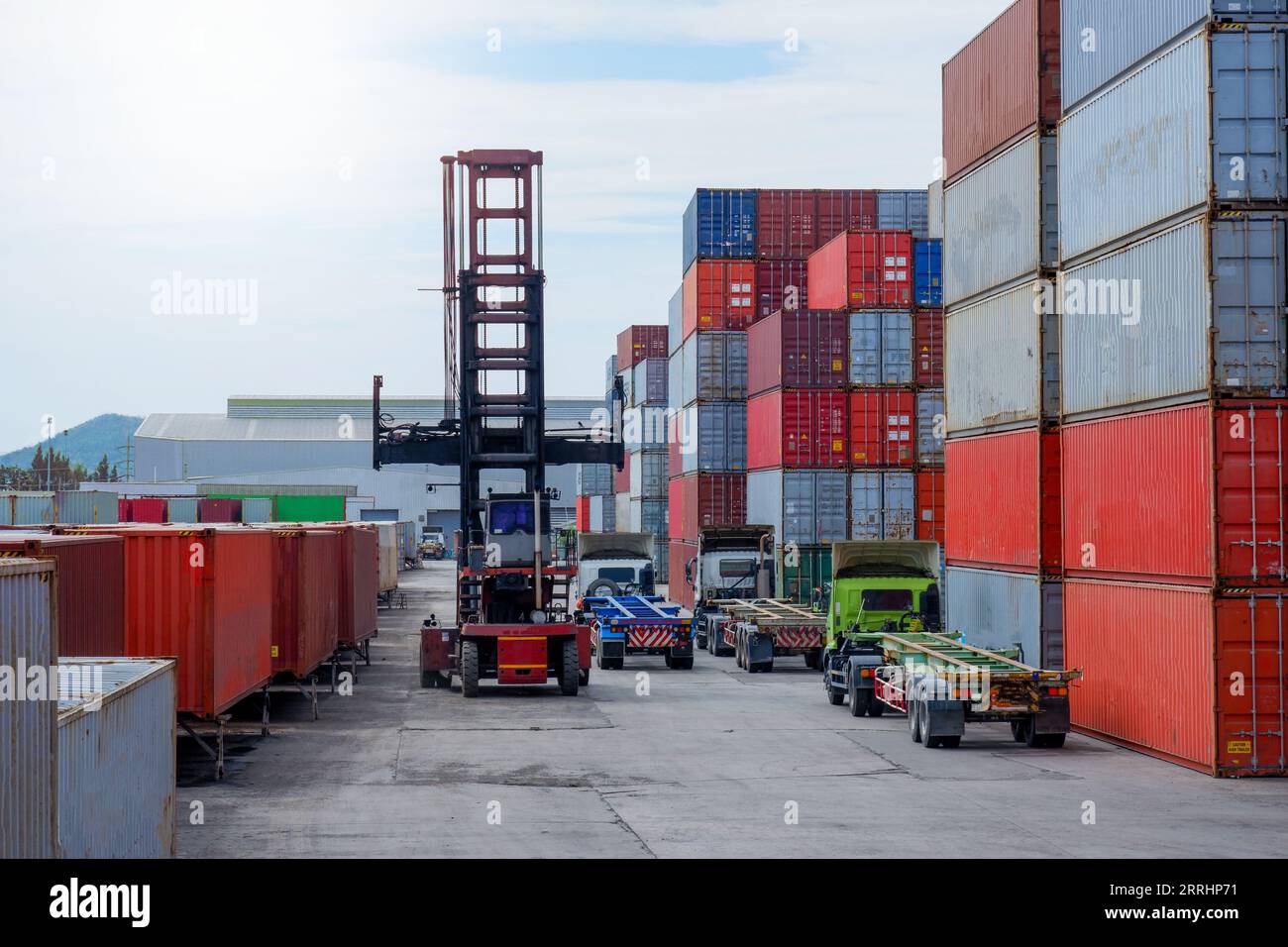 Container forklift and truck with stack of containers as background ...