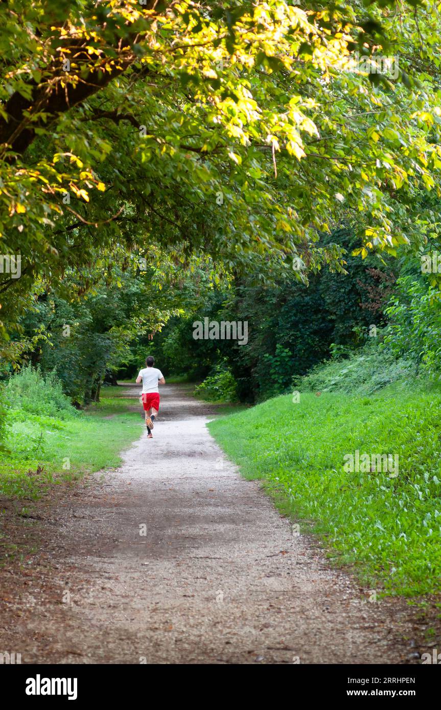 Italy, Lombardy, Man Running on Countryroad Stock Photo - Alamy