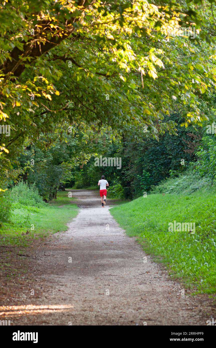 Italy, Lombardy, Man Running on Countryroad Stock Photo - Alamy