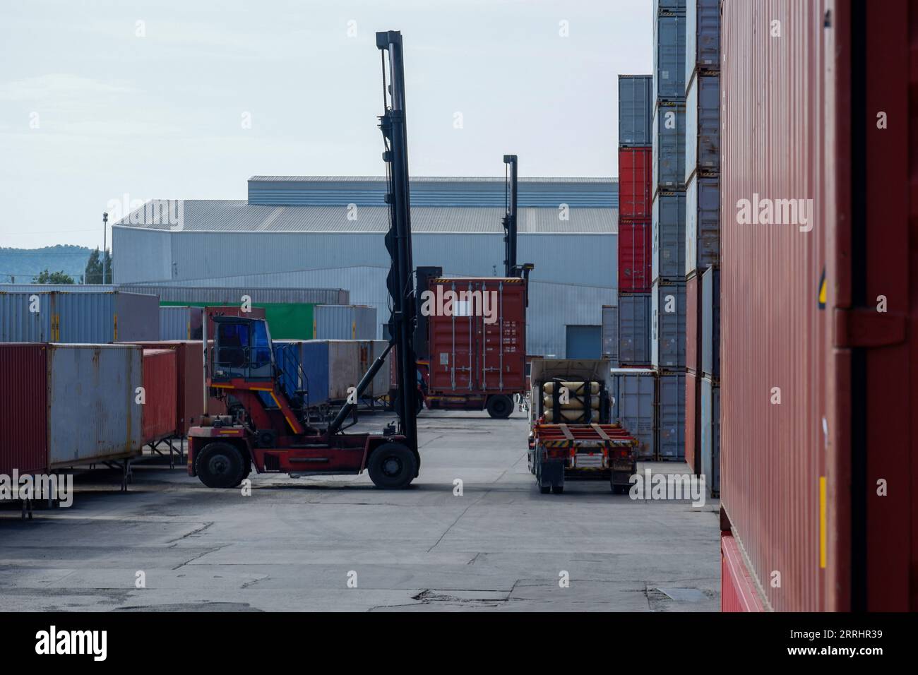 Forklift handling container boxes loaded onto truck in shipping yard ...