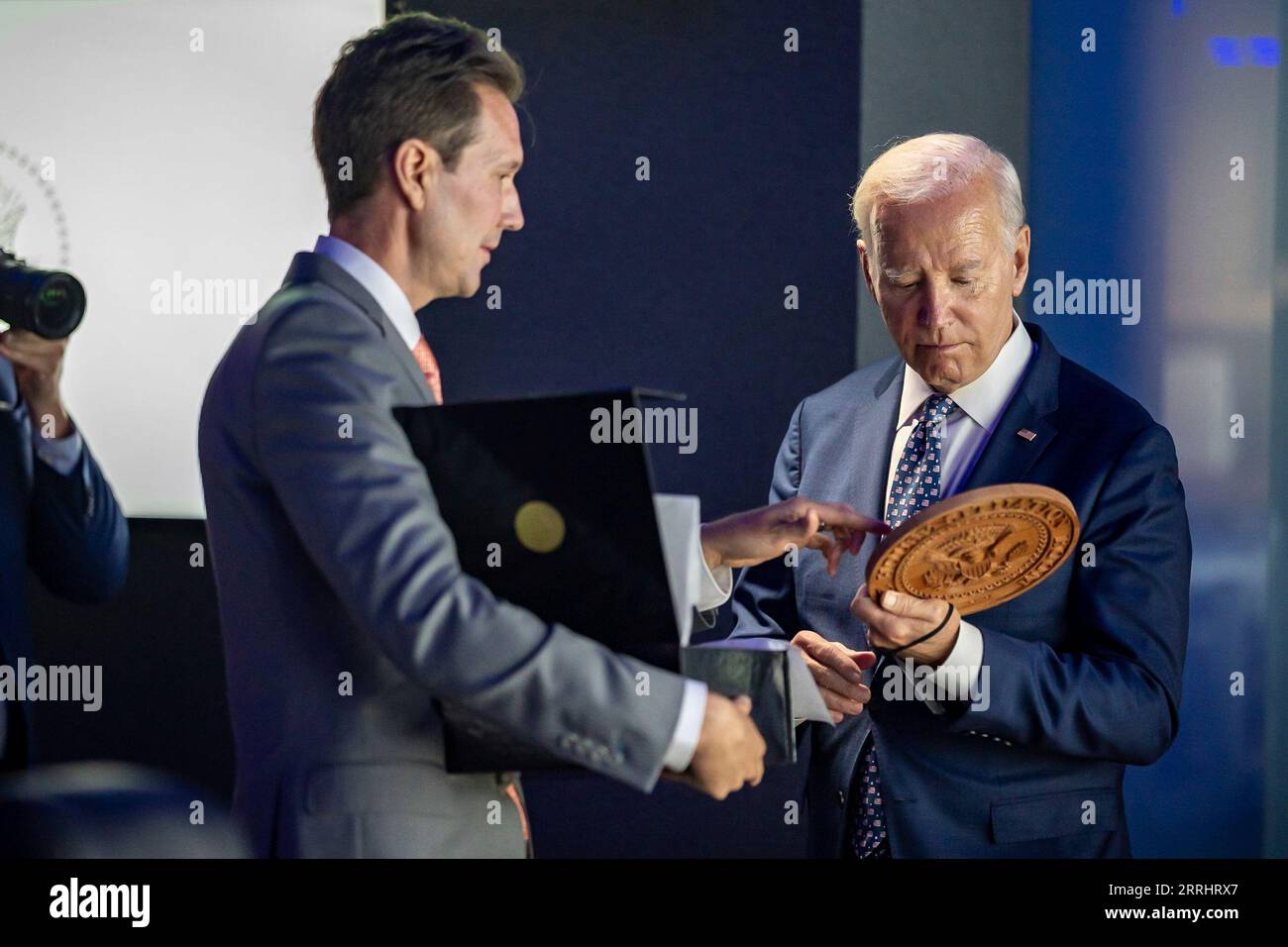 In this image provided by the White House, President Joe Biden looks at ...