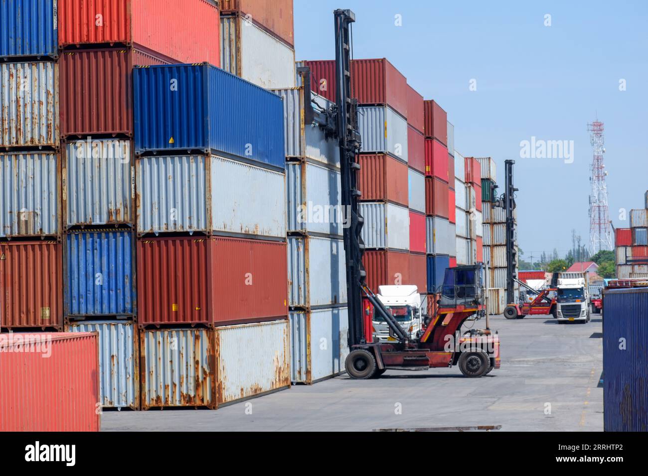 A forklift is stacking containers. perspective on import and export ...