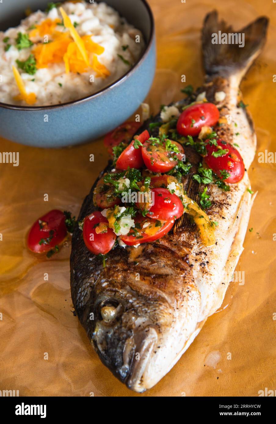 Grilled dorada fish and rice with celery root puree in a seaside ...