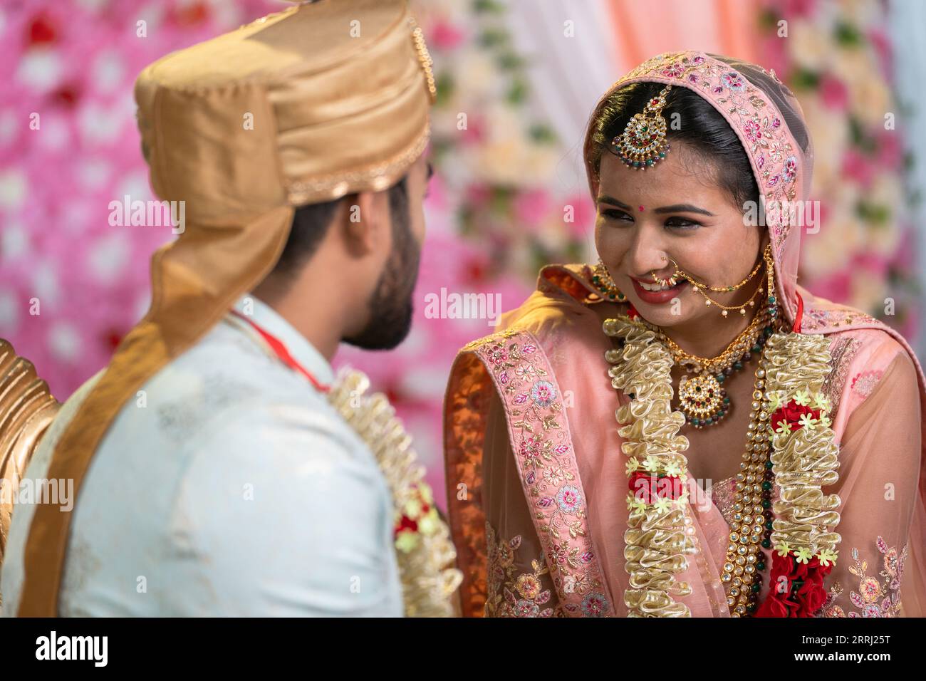 Indian happy Newly married young couples on stage talking together ...