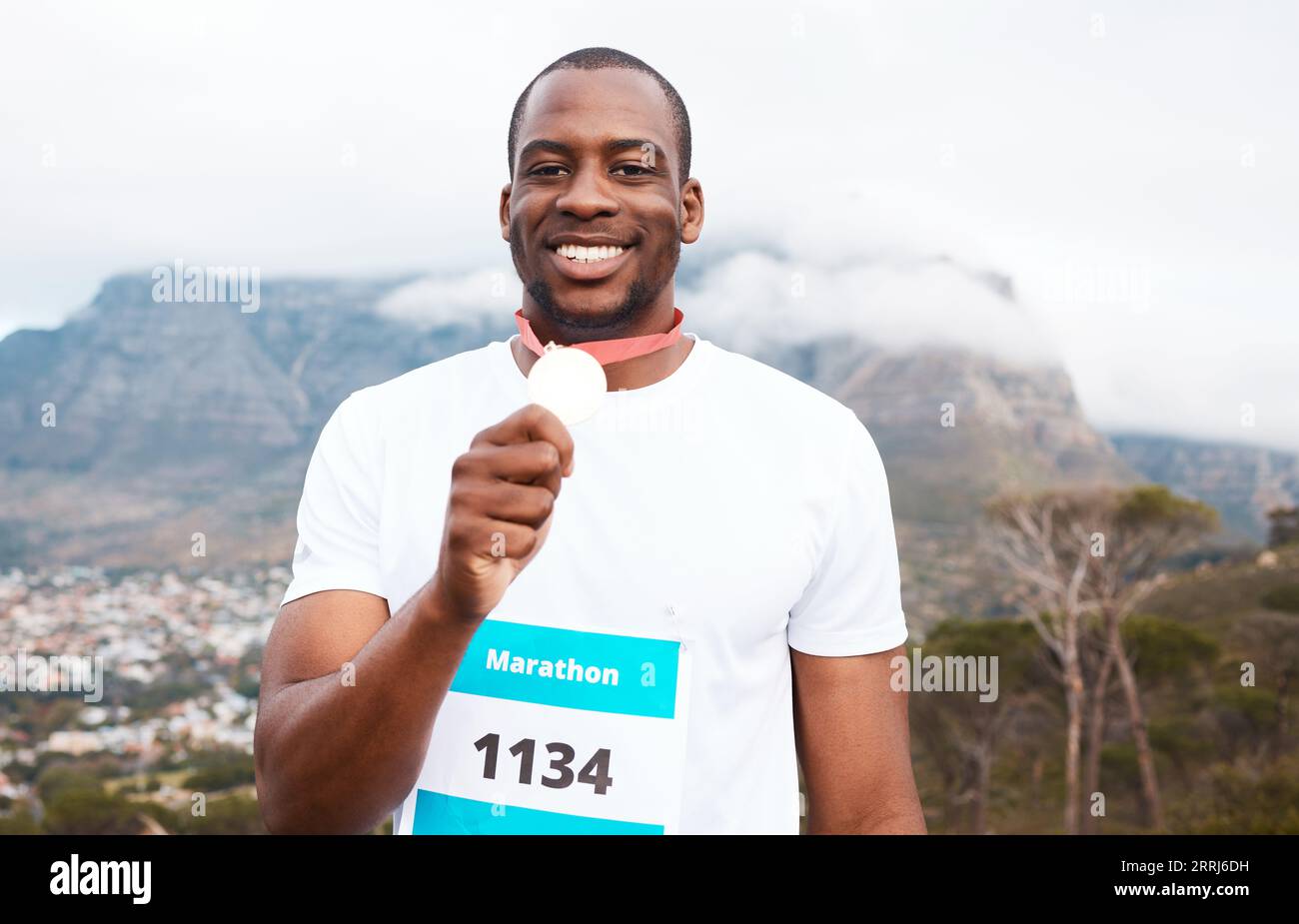 Runner man, winner and medal in portrait for marathon, competition or ...