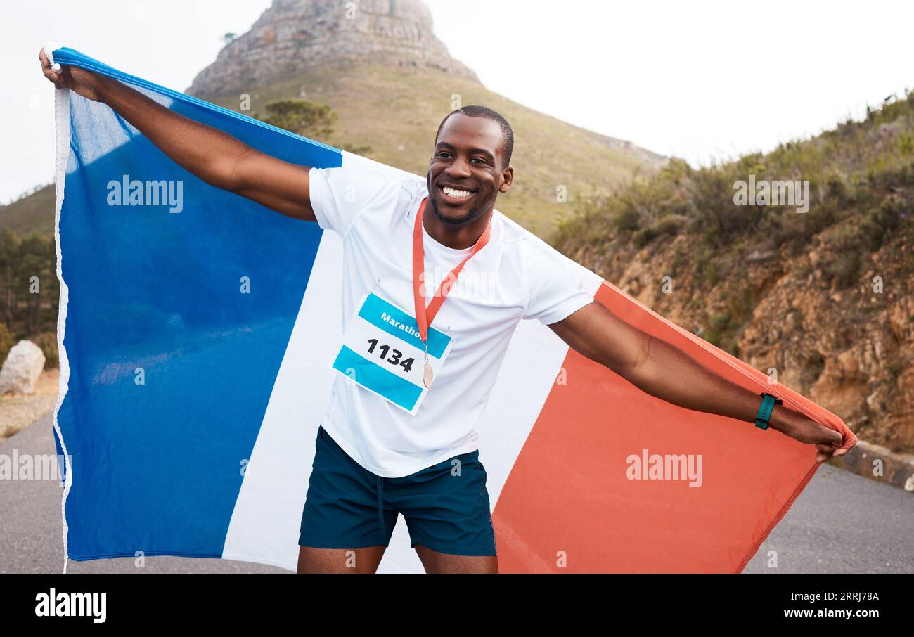 Runner man, flag and winner with smile, pride and celebration for ...