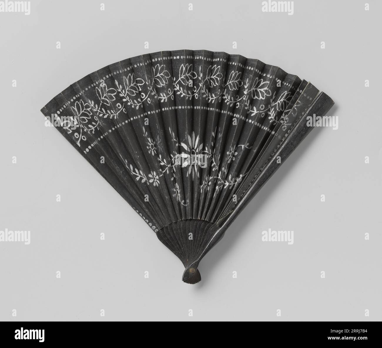 Paper mourning fan with white floral motif and frame of unadorned black ...